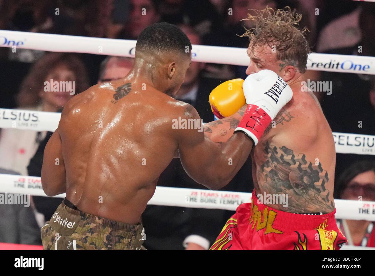 Anthony Joshua, left, and Jake Paul, right, compete during their ...