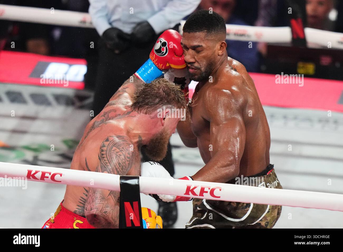 Jake Paul, left, and Anthony Joshua, right, compete during their ...