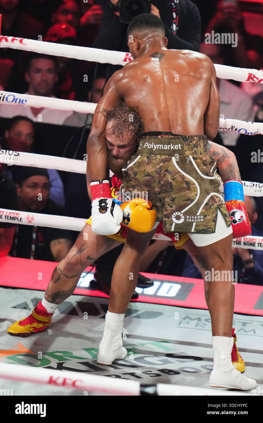 Jake Paul, left, and Anthony Joshua, right, compete during their ...