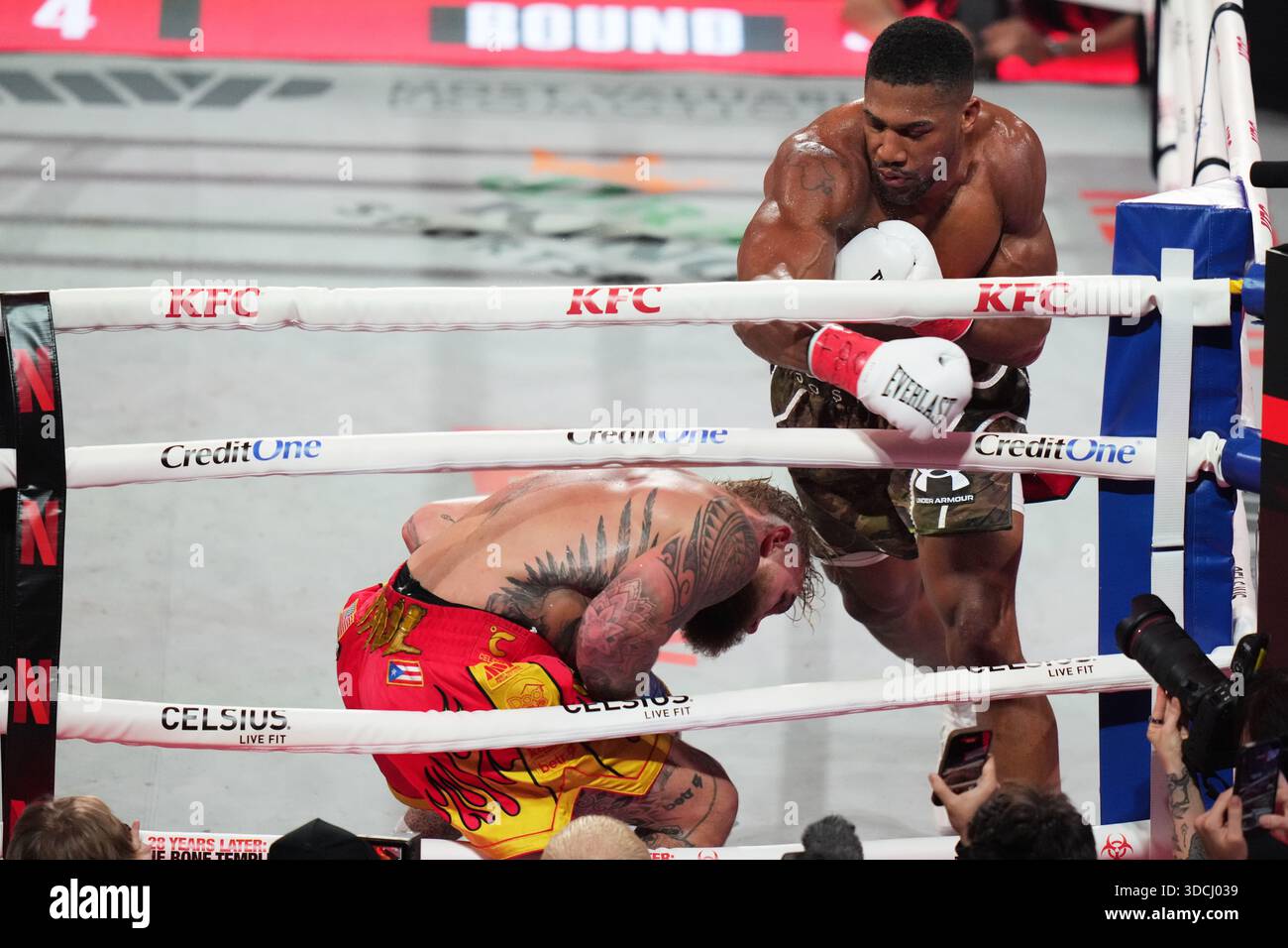 Jake Paul, left, and Anthony Joshua, right, compete during their ...