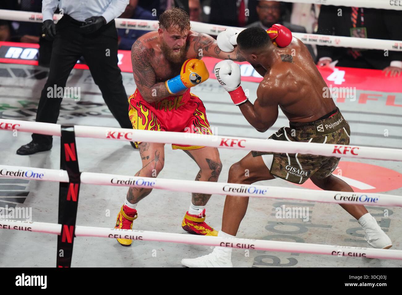 Jake Paul, left, and Anthony Joshua, right, compete during their ...