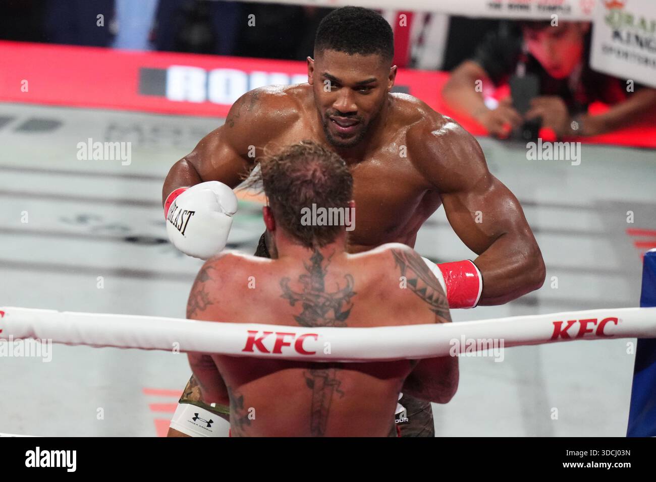 Jake Paul, front, and Anthony Joshua, rear, compete during their ...