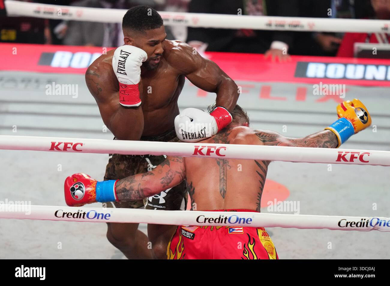 Anthony Joshua, left, and Jake Paul, right, compete during their ...