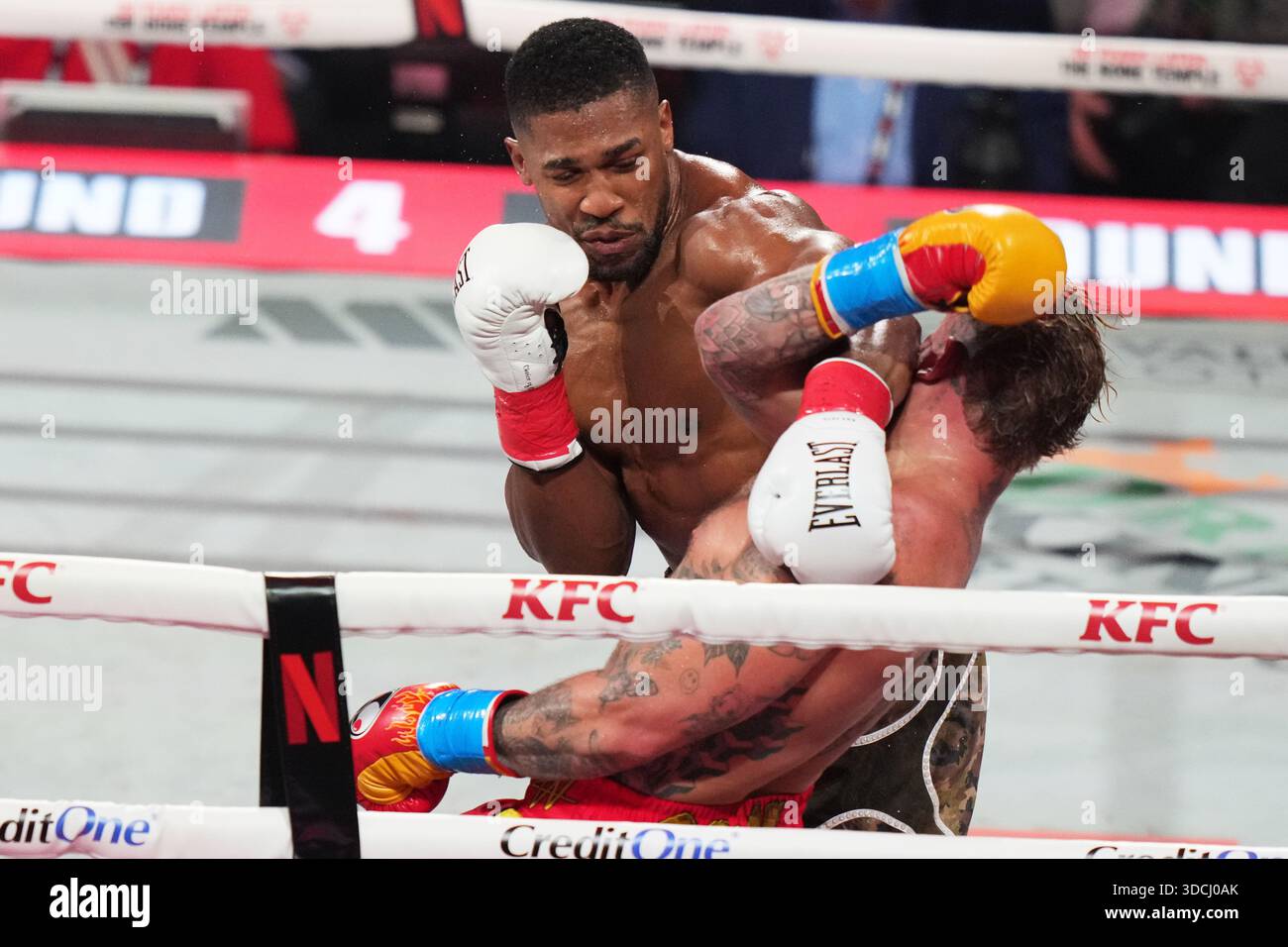 Anthony Joshua, left, and Jake Paul, right, compete during their ...