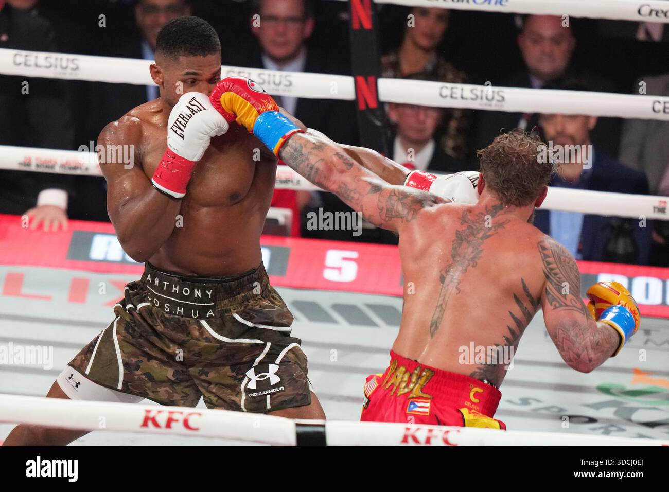 Anthony Joshua, left, and Jake Paul, right, compete during their ...