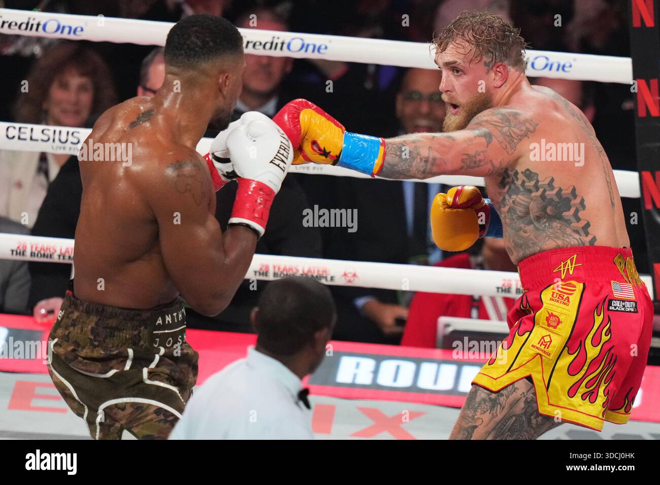 Anthony Joshua, left, and Jake Paul, right, compete during their ...