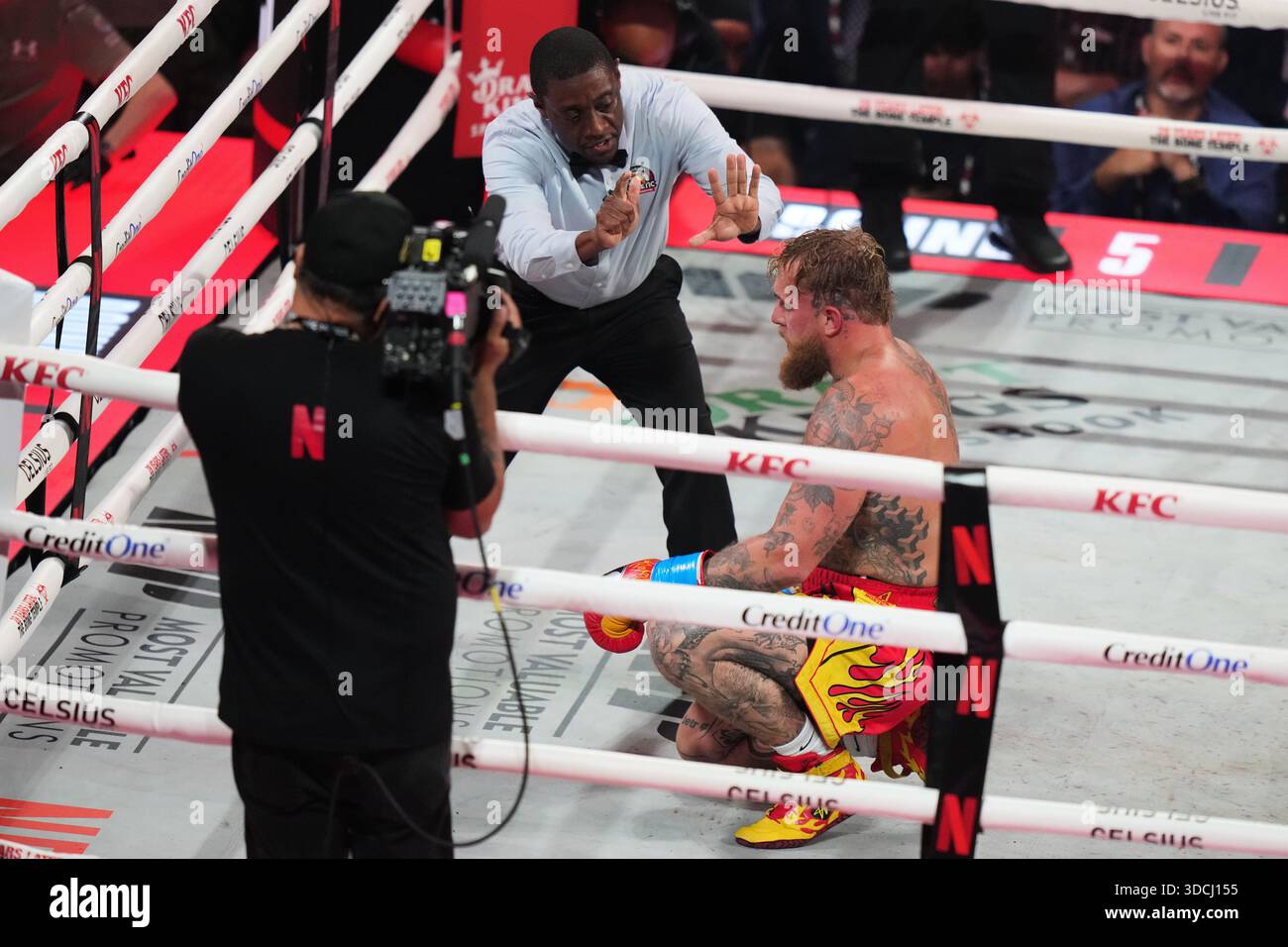 Jake Paul sits on the canvas during his heavyweight boxing match ...