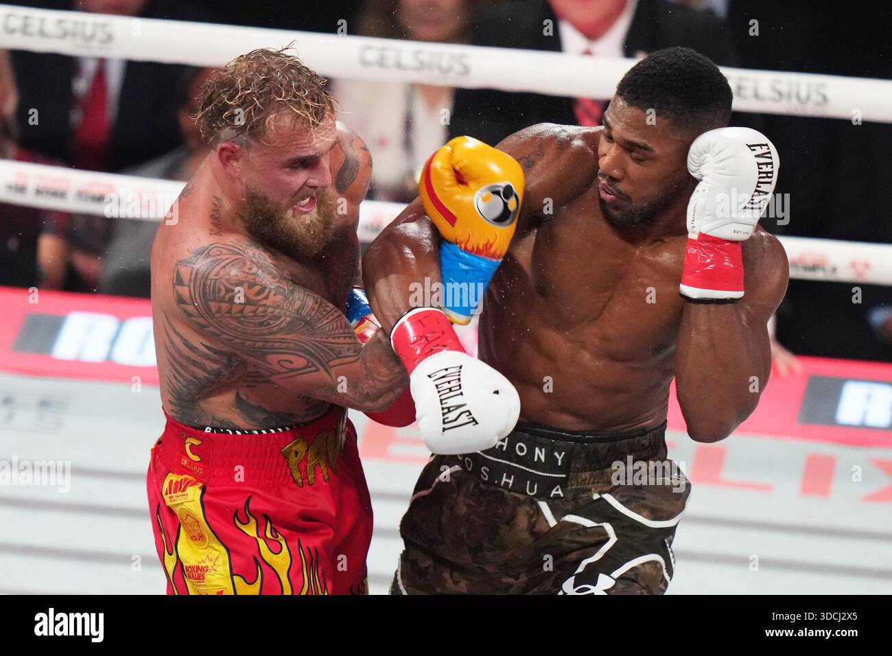 Jake Paul, left, and Anthony Joshua, right, compete during their ...