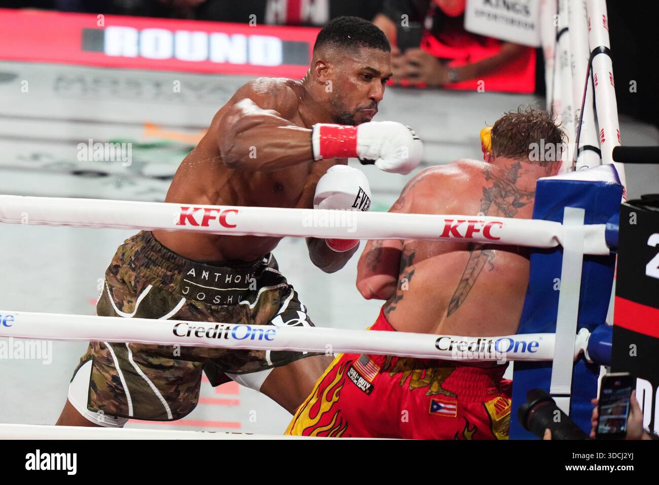 Anthony Joshua, left, and Jake Paul, right, compete during their ...