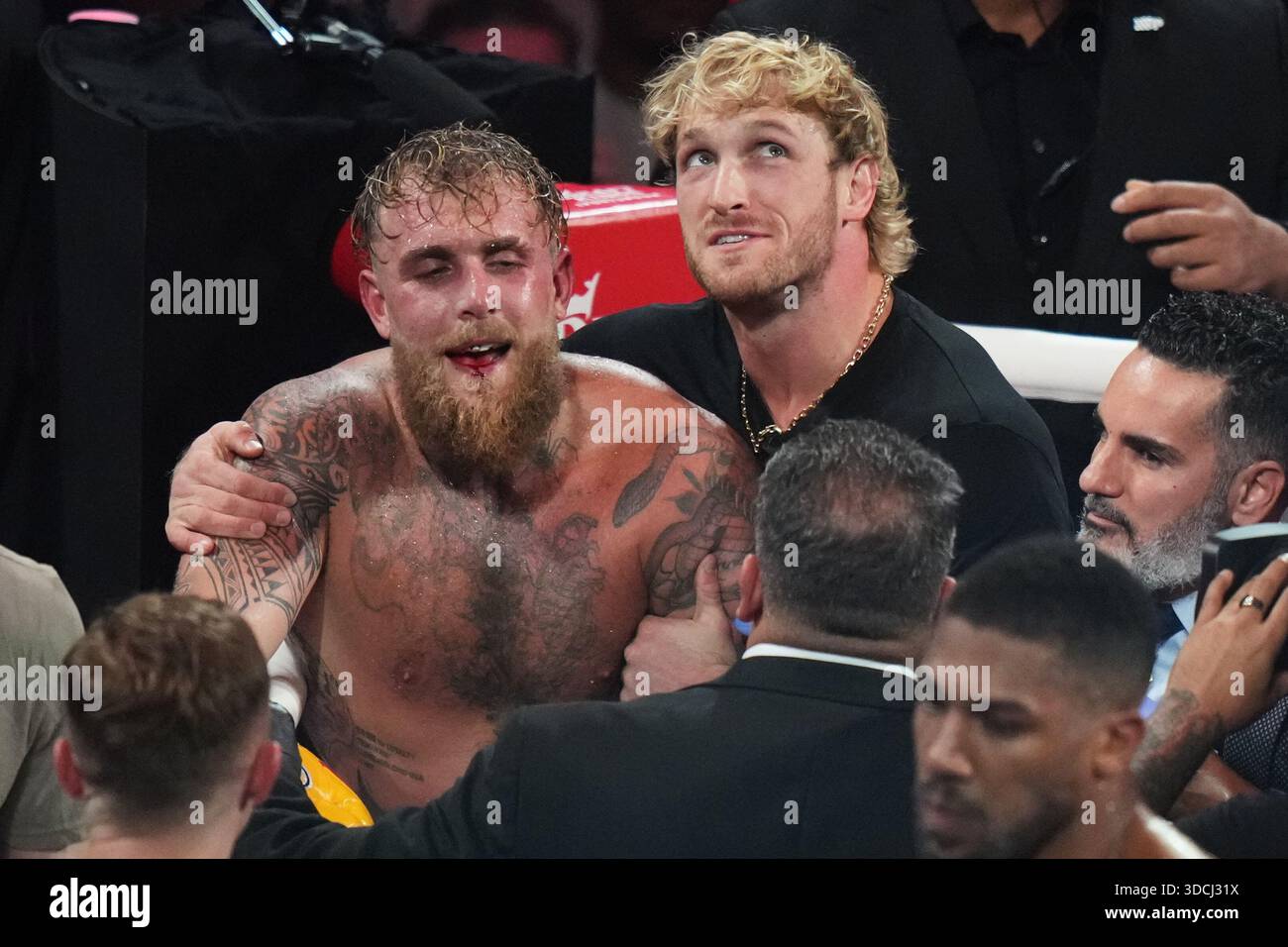 Jake Paul, left, stands with his brother Logan Paul, right, after his ...