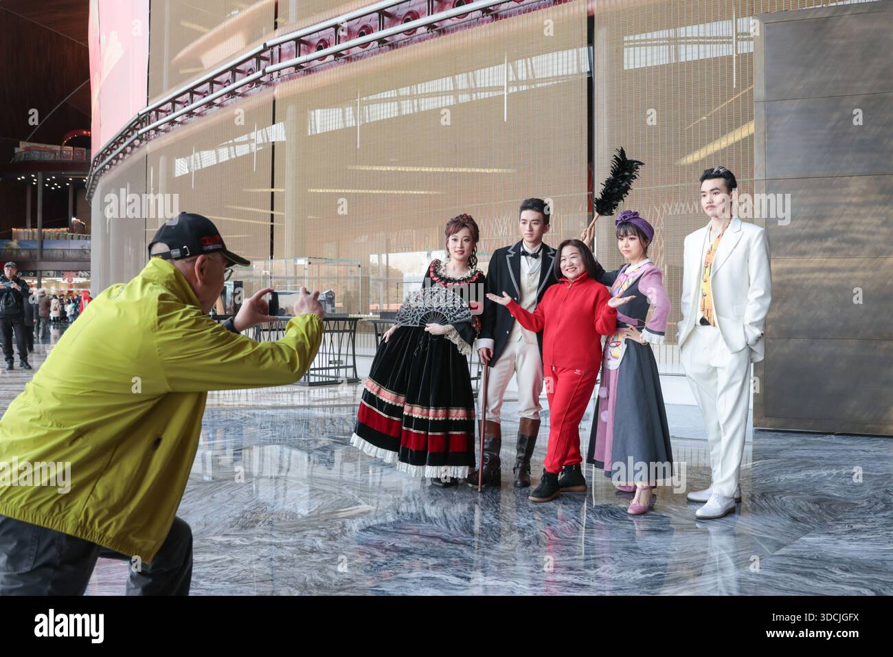 A visitor takes a group photo with the actors of play “A Doll’s House ...