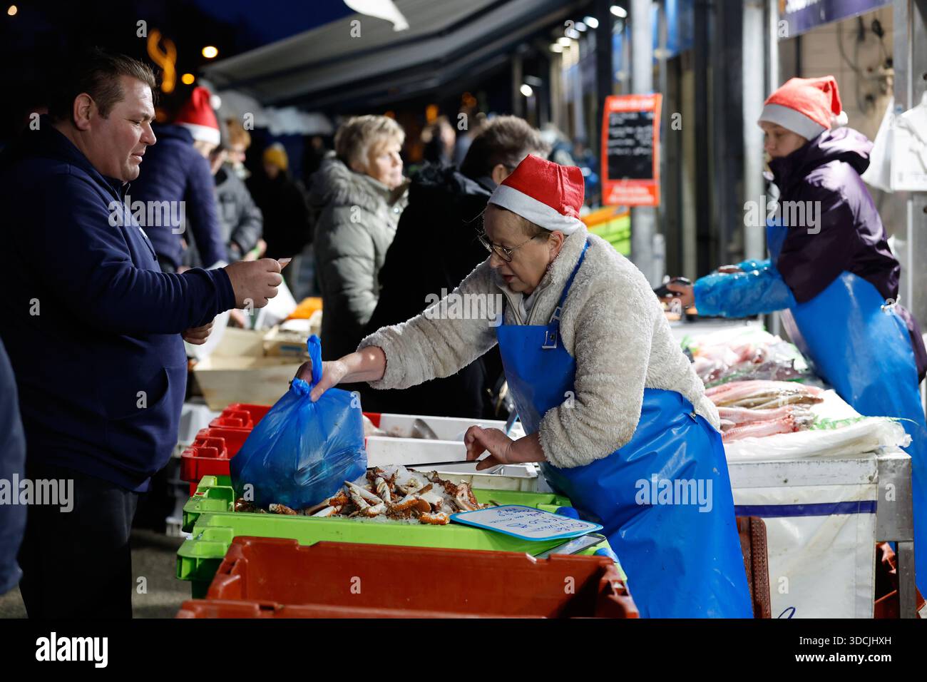 Customers buy seafood for the traditional Christmas Eve dinners ...