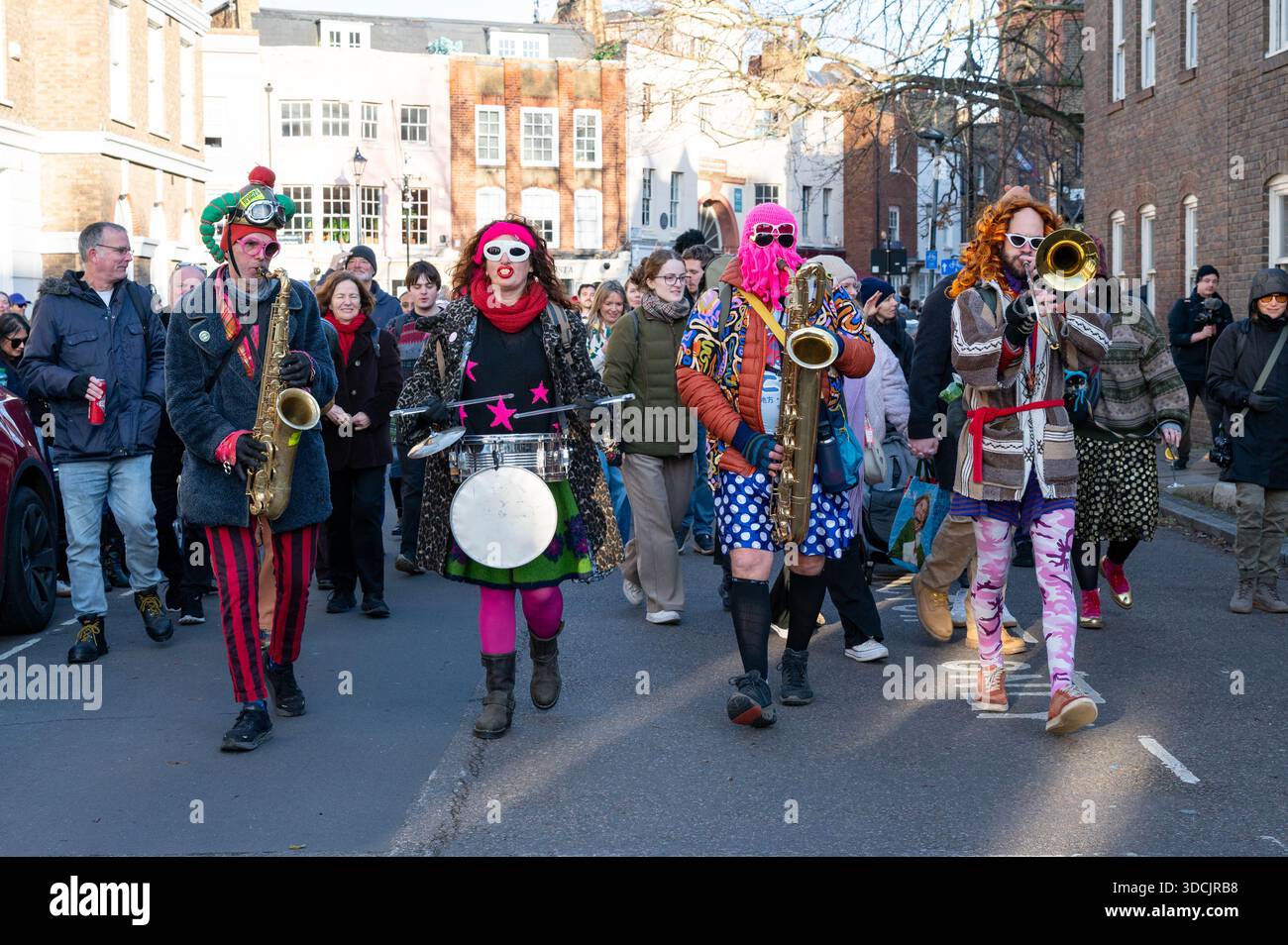 A musical band plays while accompanying the race. People in traditional ...