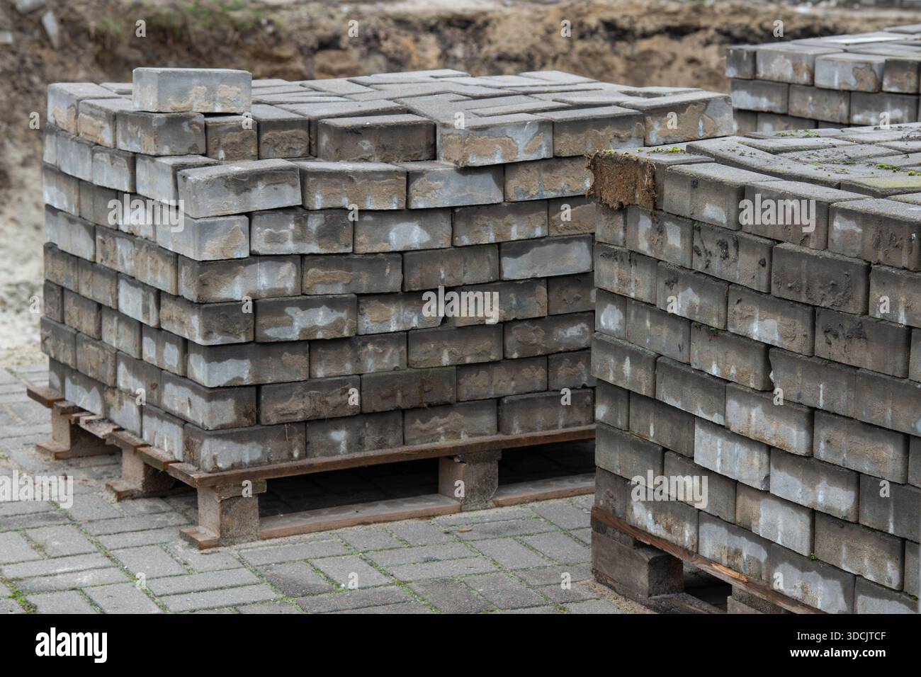 Large stacks of concrete paving bricks on wooden pallets near ...