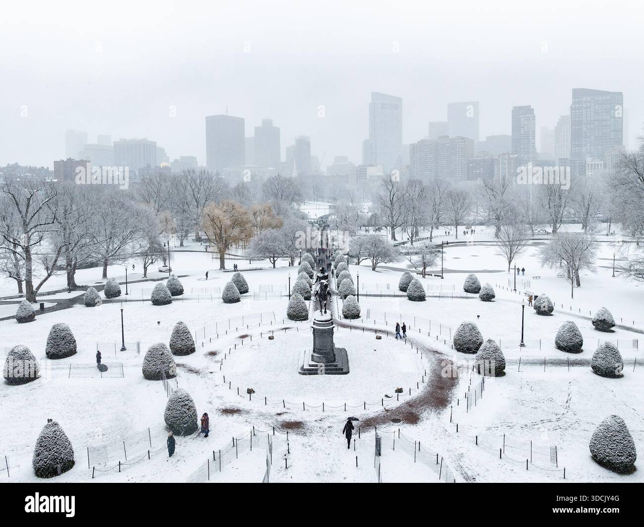 Aerial view of Boston Public Garden and city skyline blanketed in ...