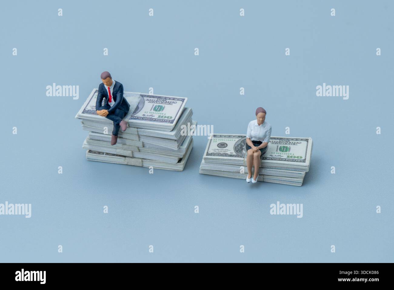 Man and woman figures sitting on unequal stacks of dollar bills. Gender ...