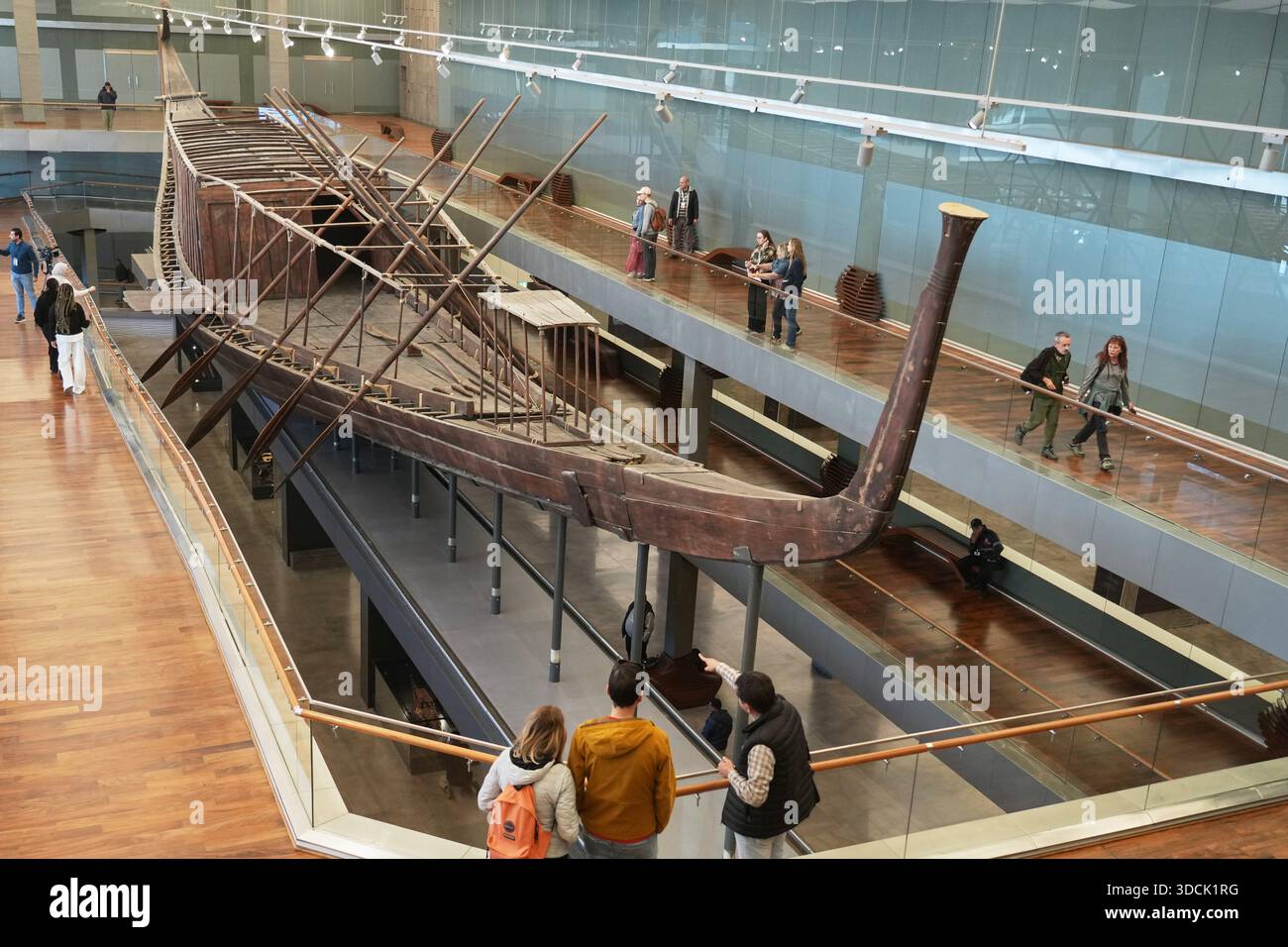 Visitors view the first solar boat of King Khufu, at the Grand Egyptian ...