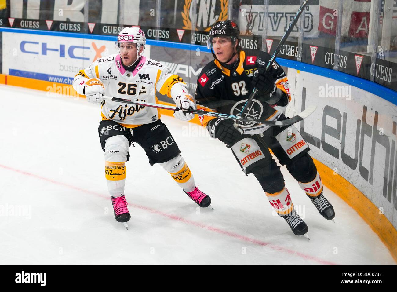 PORZA, SWITZERLAND - DECEMBER 22: Kevin Fey of Ajoie L) against Mike ...