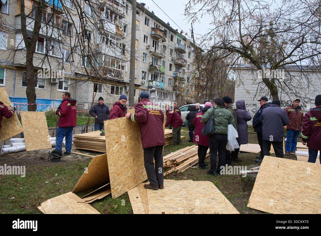 Municipal workers offer plywood to residents to cover their broken ...