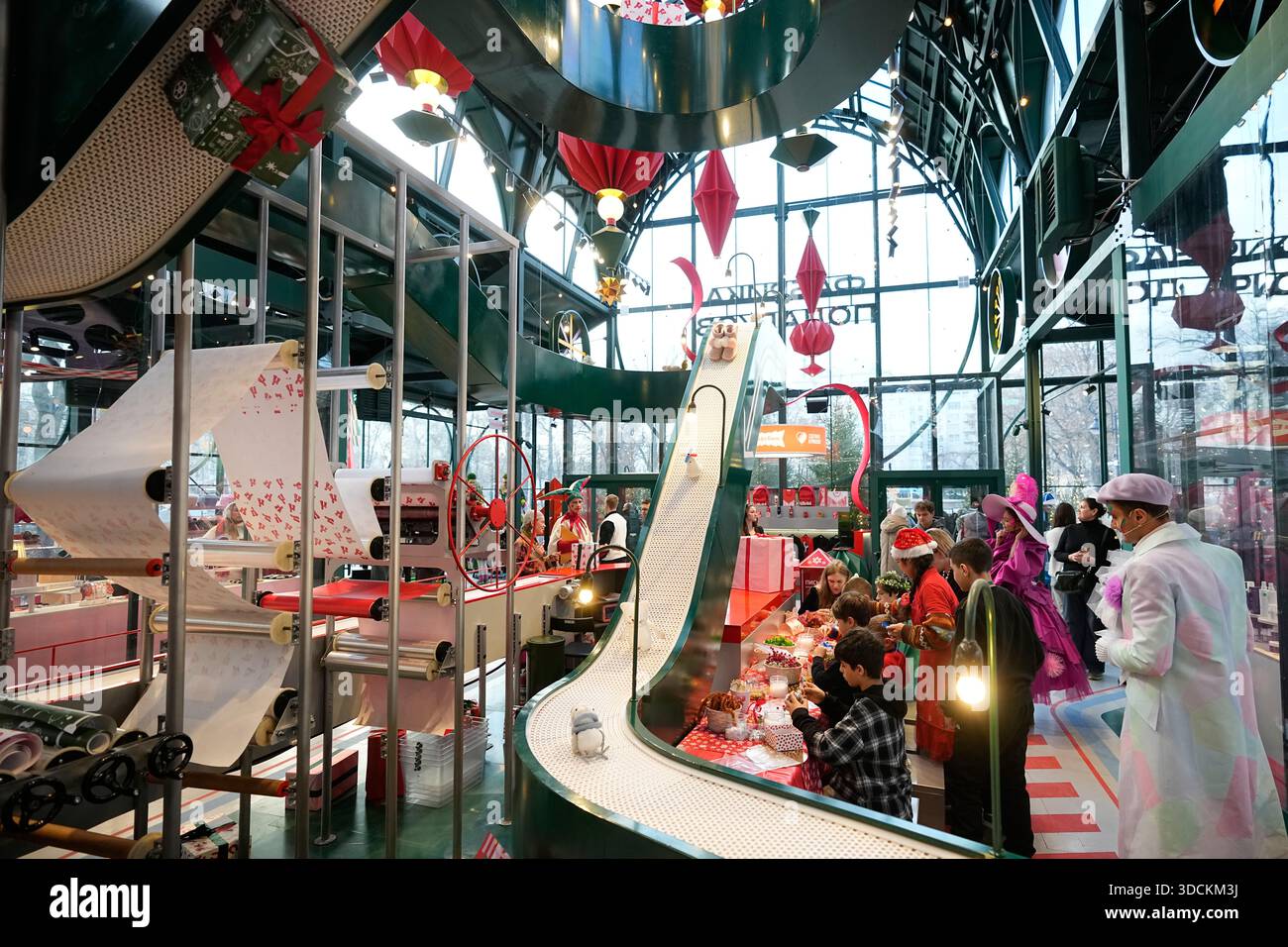 Children make Christmas tree decorations at the Gift Factory pavilion ...