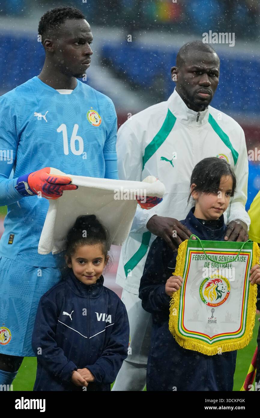 Senegal's goalkeeper Edouard Mendy protects a girl from rain before the ...