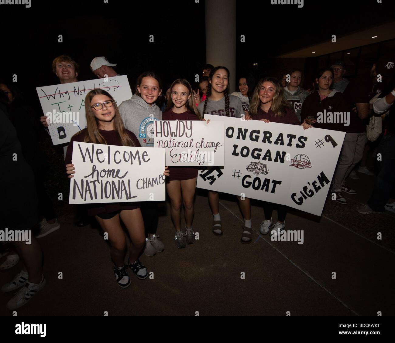 Fans wait with signs for the arrival of the national champion Texas A&M ...