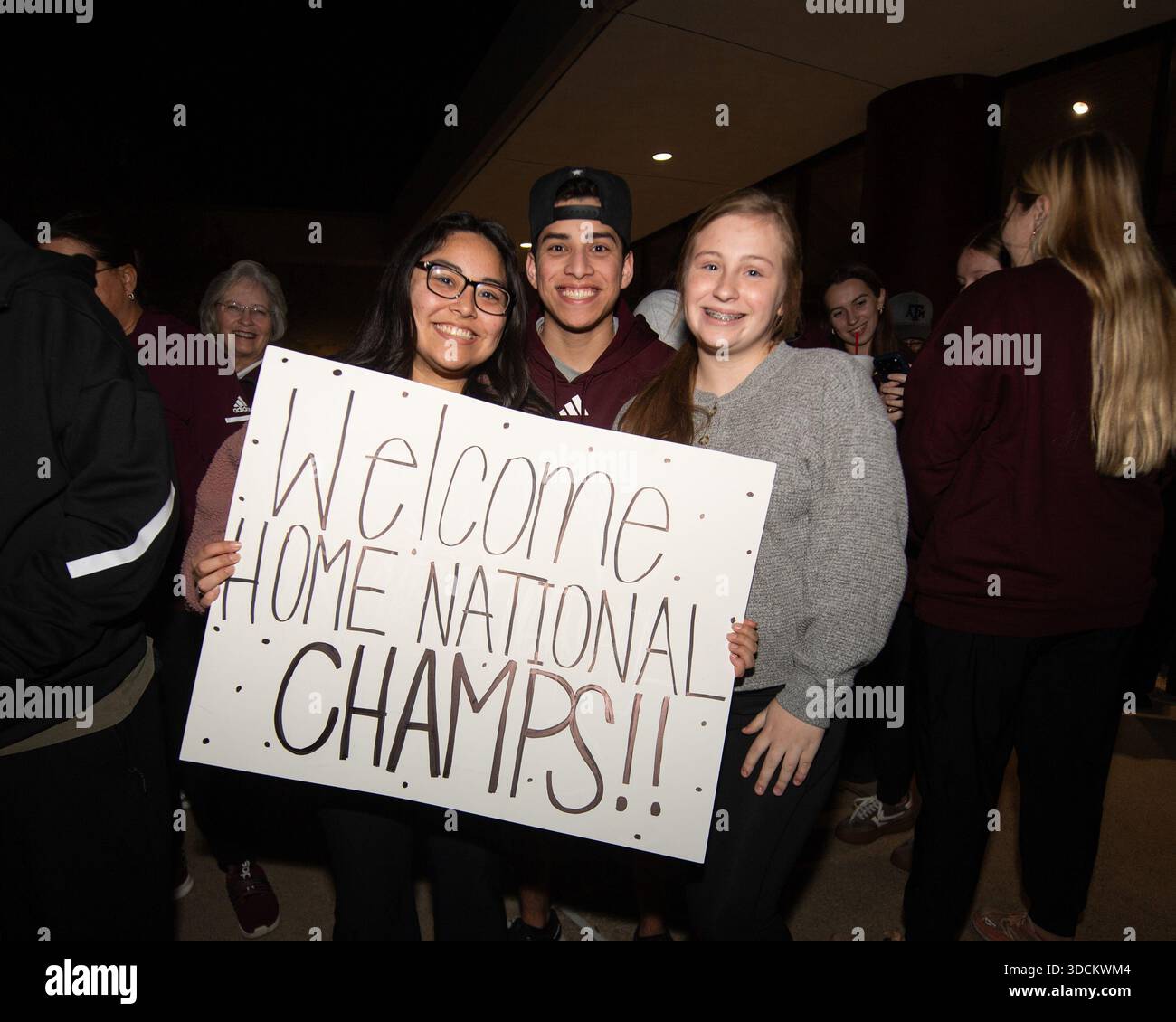 Fans wait with signs for the arrival of the national champion Texas A&M ...