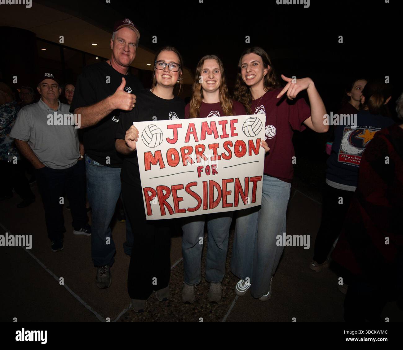 Fans wait with signs for the arrival of the national champion Texas A&M ...