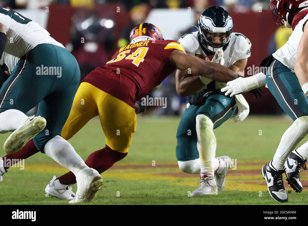 Washington Commanders linebacker Bobby Wagner (54) lays a hard hit on ...