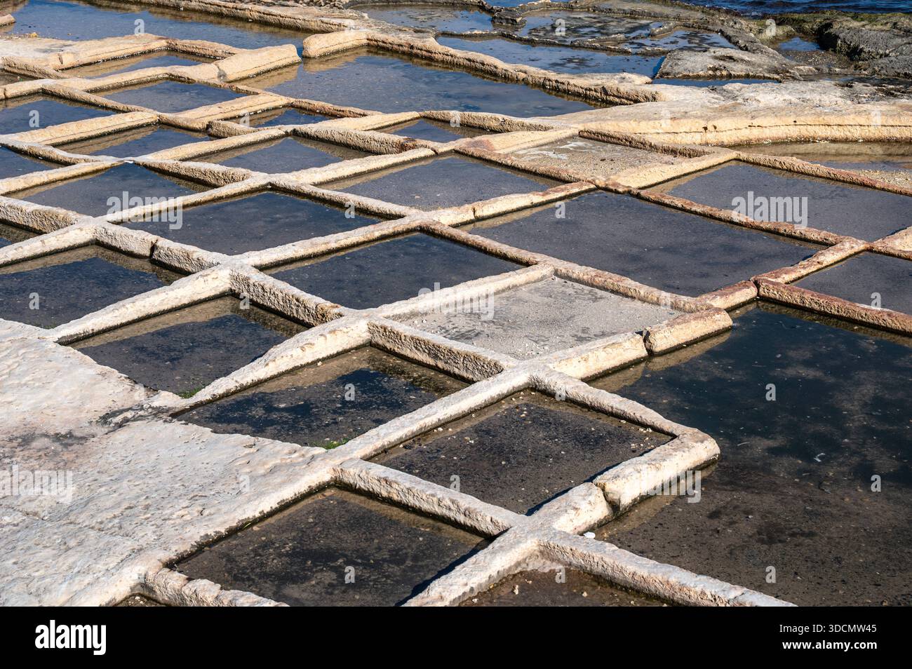 Colorful natural salt pans along the rocky coastline of BirÅ¼ebbuÄa ...