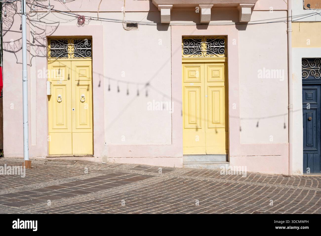 Old weathered limestone houses in vibrant colors in the coastal village ...