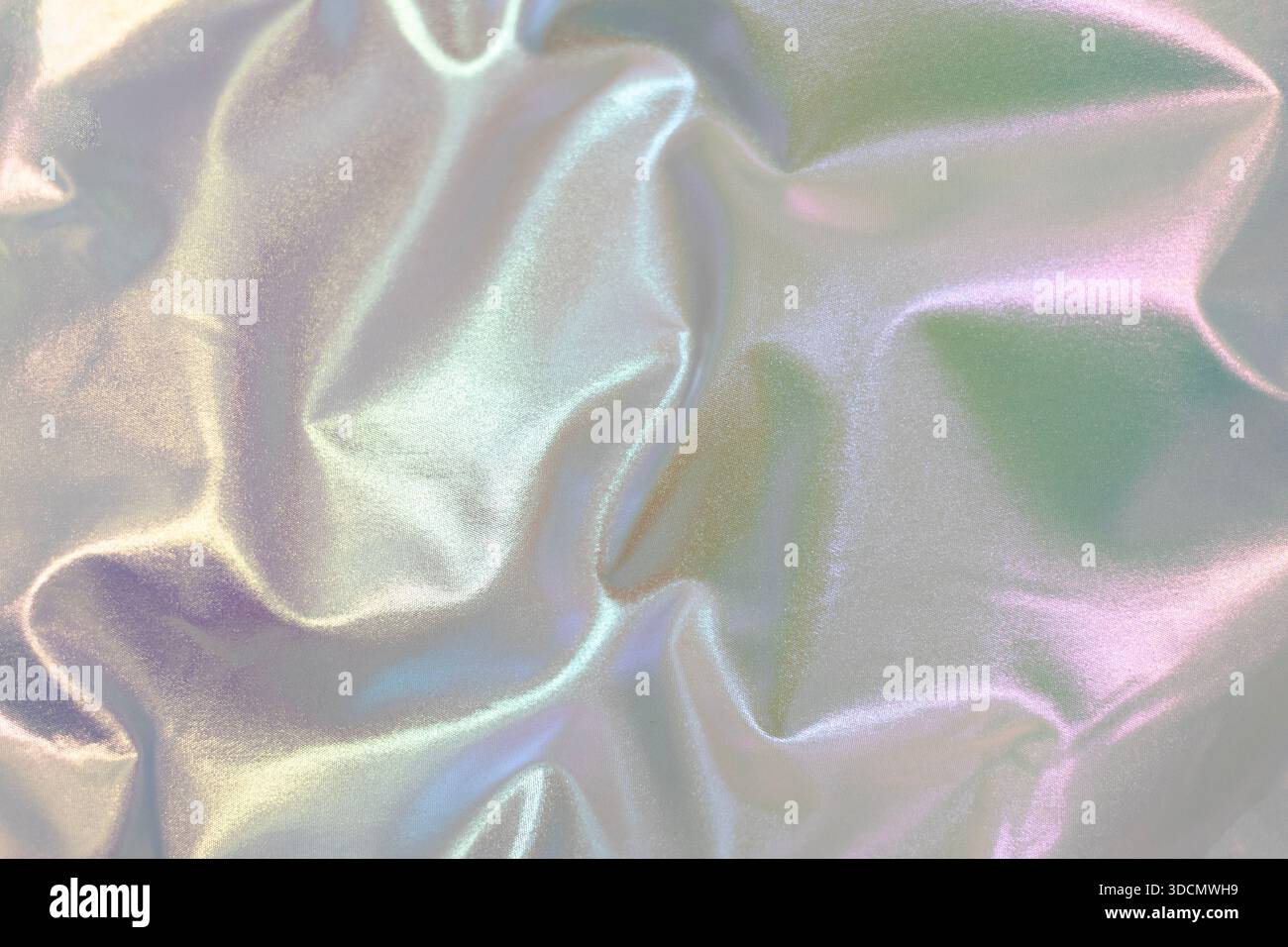 Iridescent satin fabric folds create soft glow and reflective light for ...