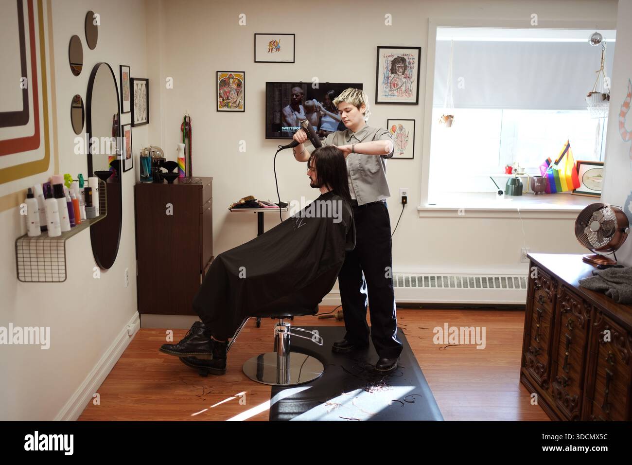 Jenai Baker, right, a non-binary hairstylist offering free and pay-what ...