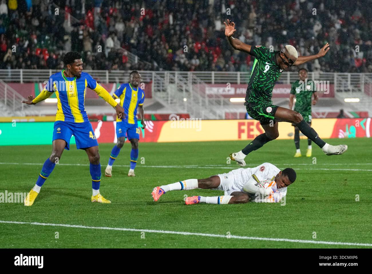 Nigeria's Victor Osimhen jumps over Tanzania's goalkeeper Hussein ...