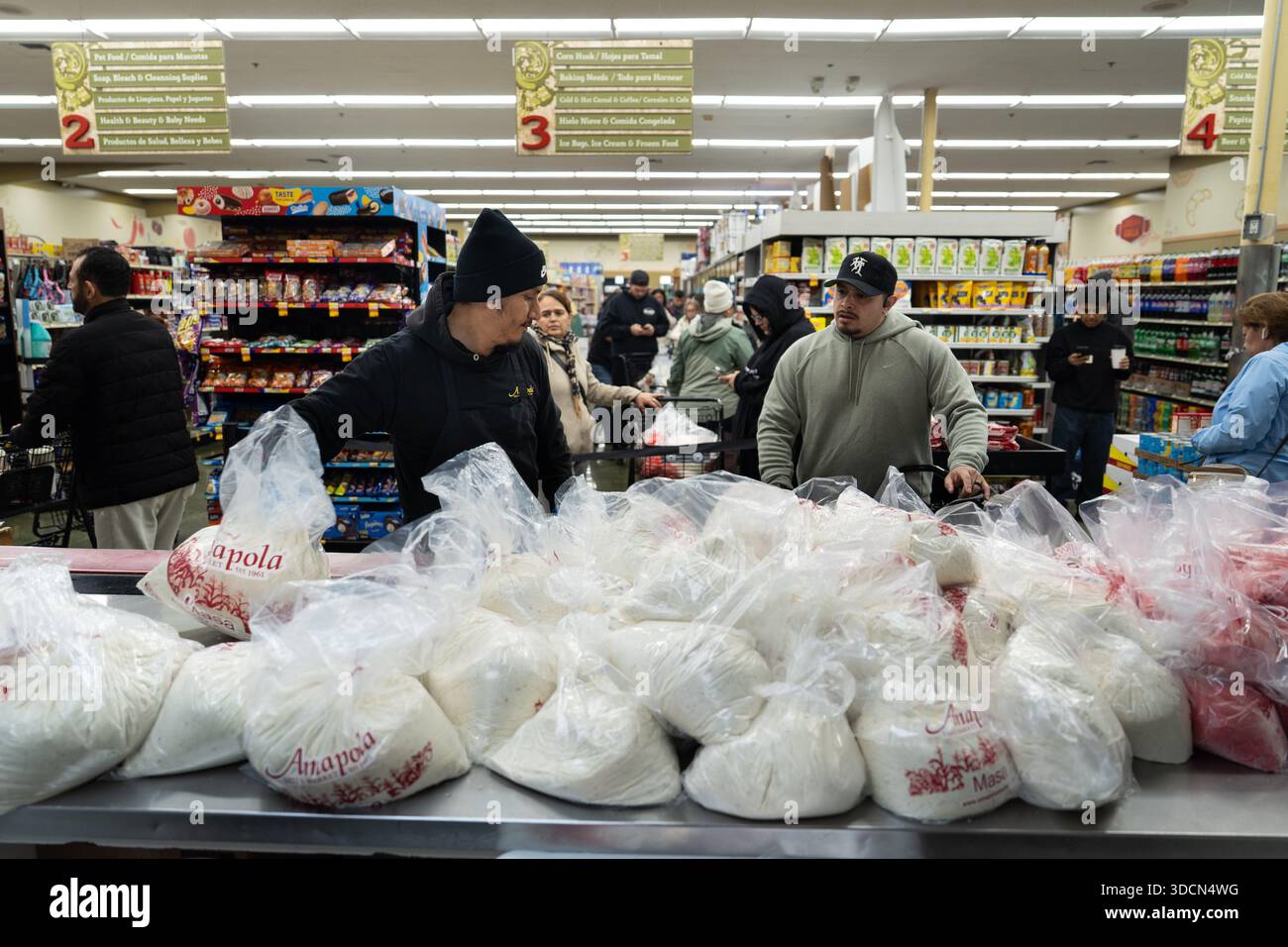 Alex Diaz, left, reaches for a bag of masa, a dough used to make ...