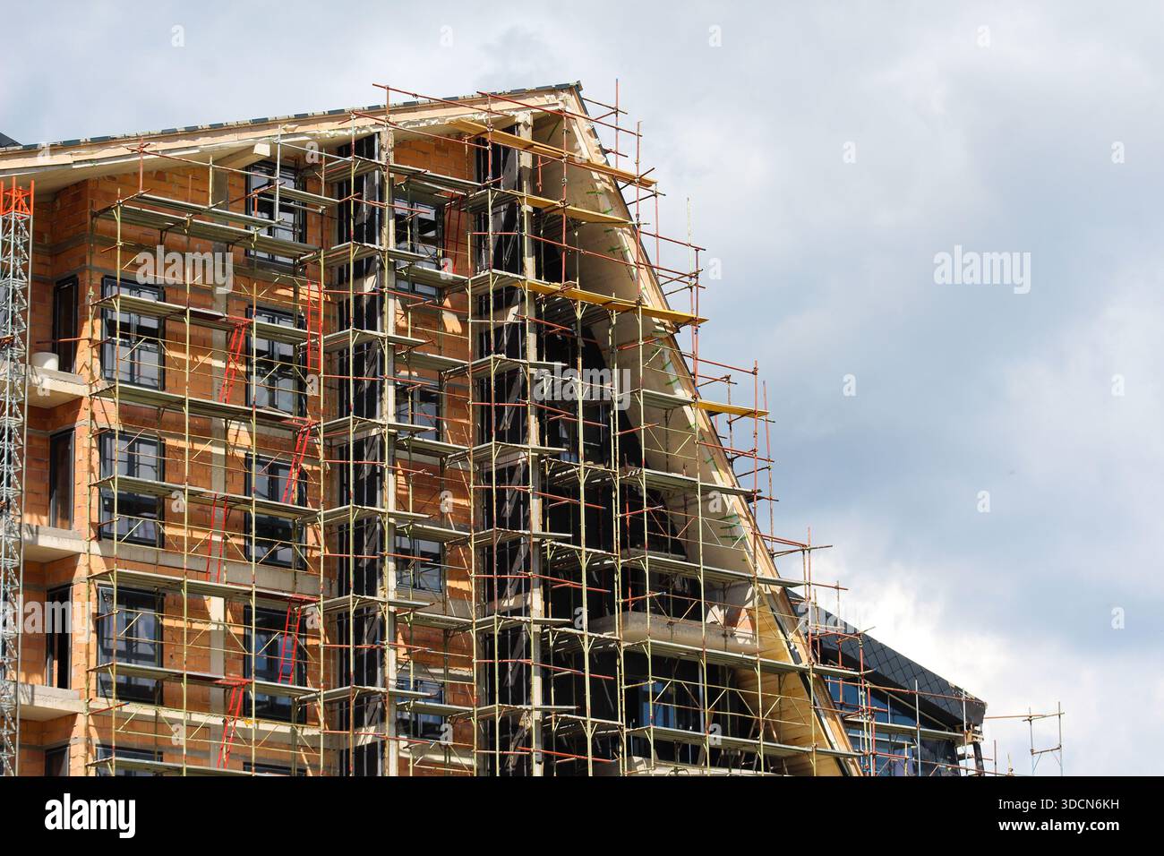 Contemporary residential building under construction, featuring exposed ...