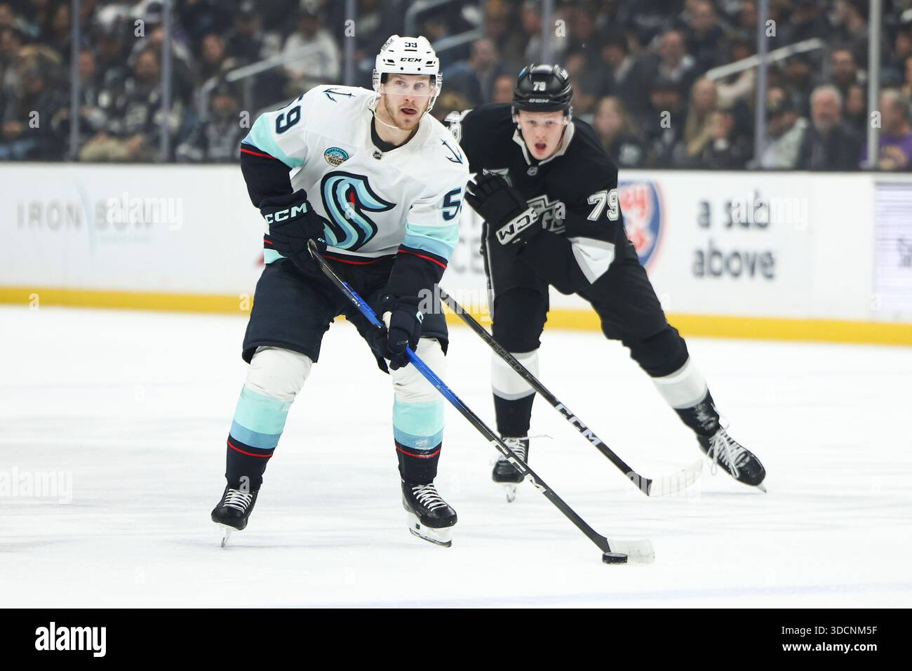 Seattle Kraken center Ben Meyers, front, skates as Los Angeles Kings ...