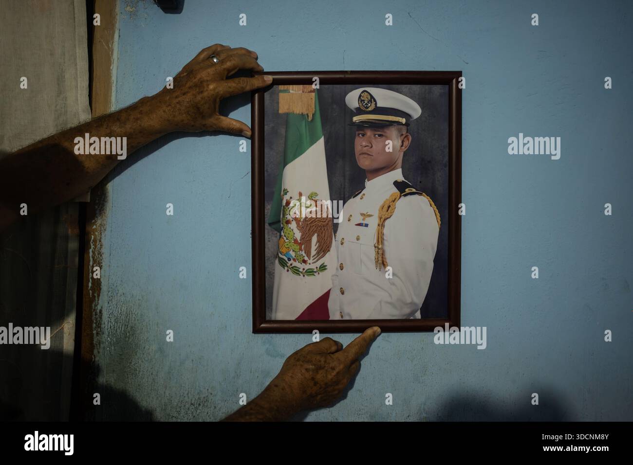 Eduardo Castillo shows a portrait of his son Lt. Luis Enrique Castillo ...