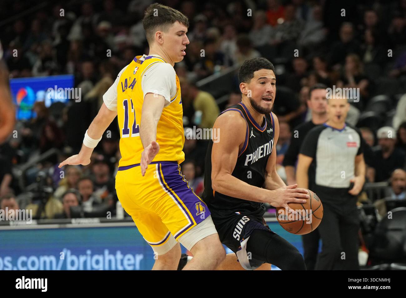 Phoenix Suns guard Devin Booker drives past Los Angeles Lakers forward ...
