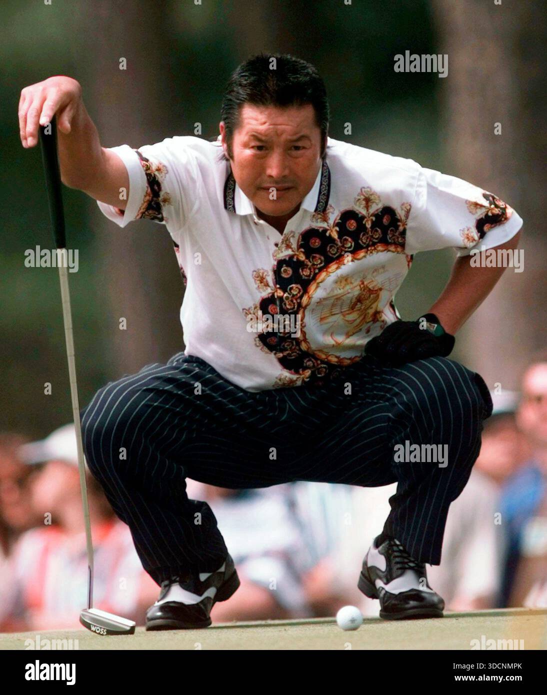 FILE - Japan's Jumbo Ozaki lines up his putt on the first green during ...