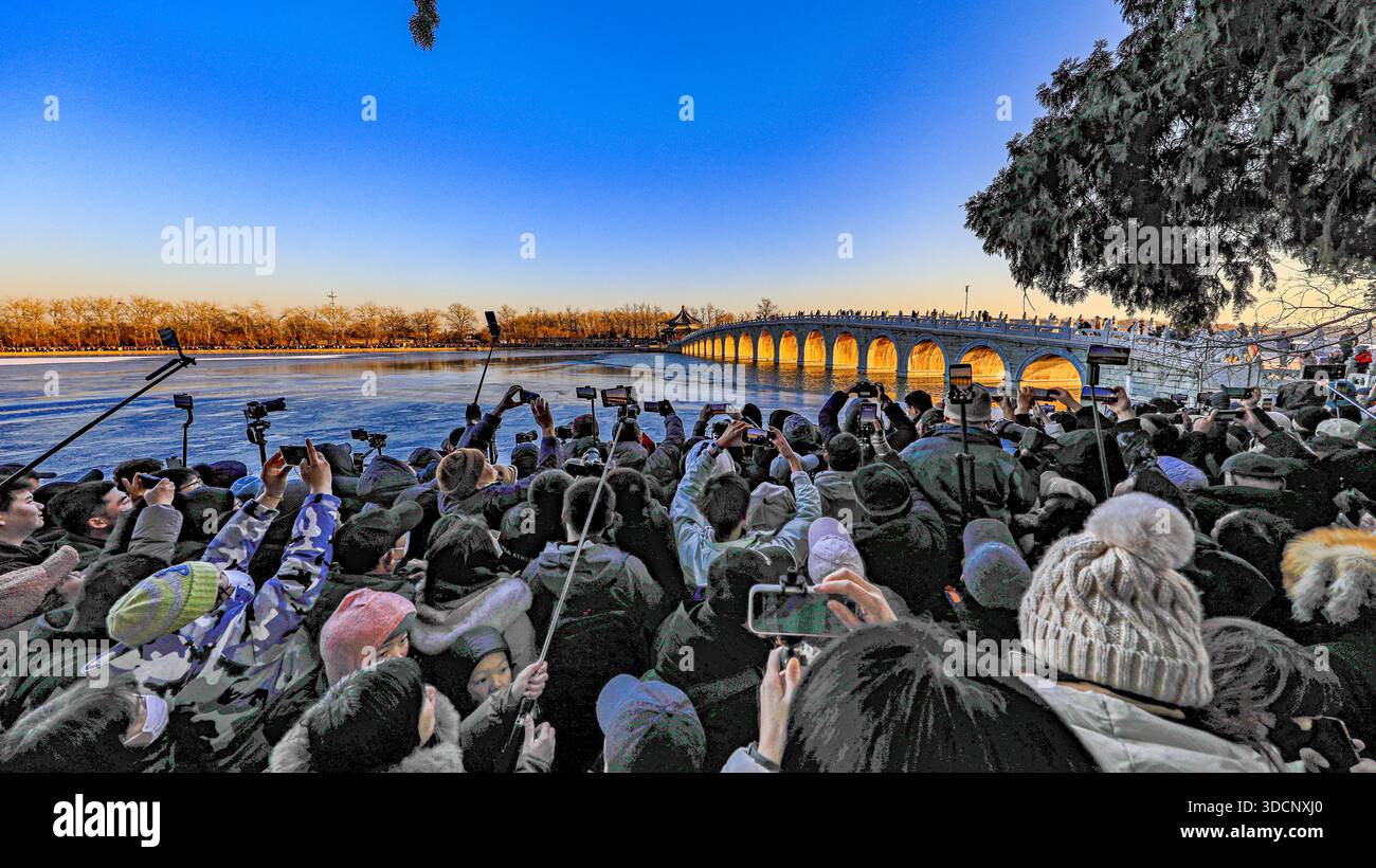 Sunset rays illuminate the Seventeen-Arch Bridge at the Summer Palace ...
