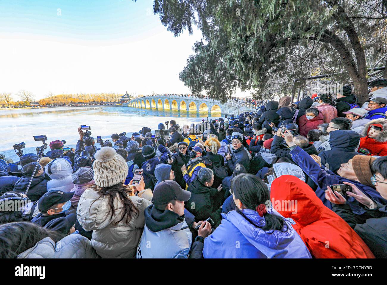 Sunset rays illuminate the Seventeen-Arch Bridge at the Summer Palace ...