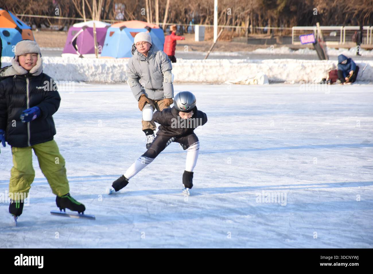 People enjoy skating at an ice rink in Harbin City, northeast China's ...