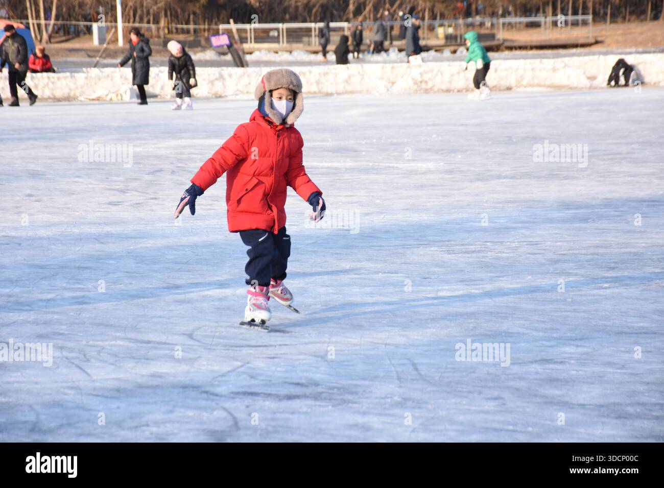 People enjoy skating at an ice rink in Harbin City, northeast China's ...