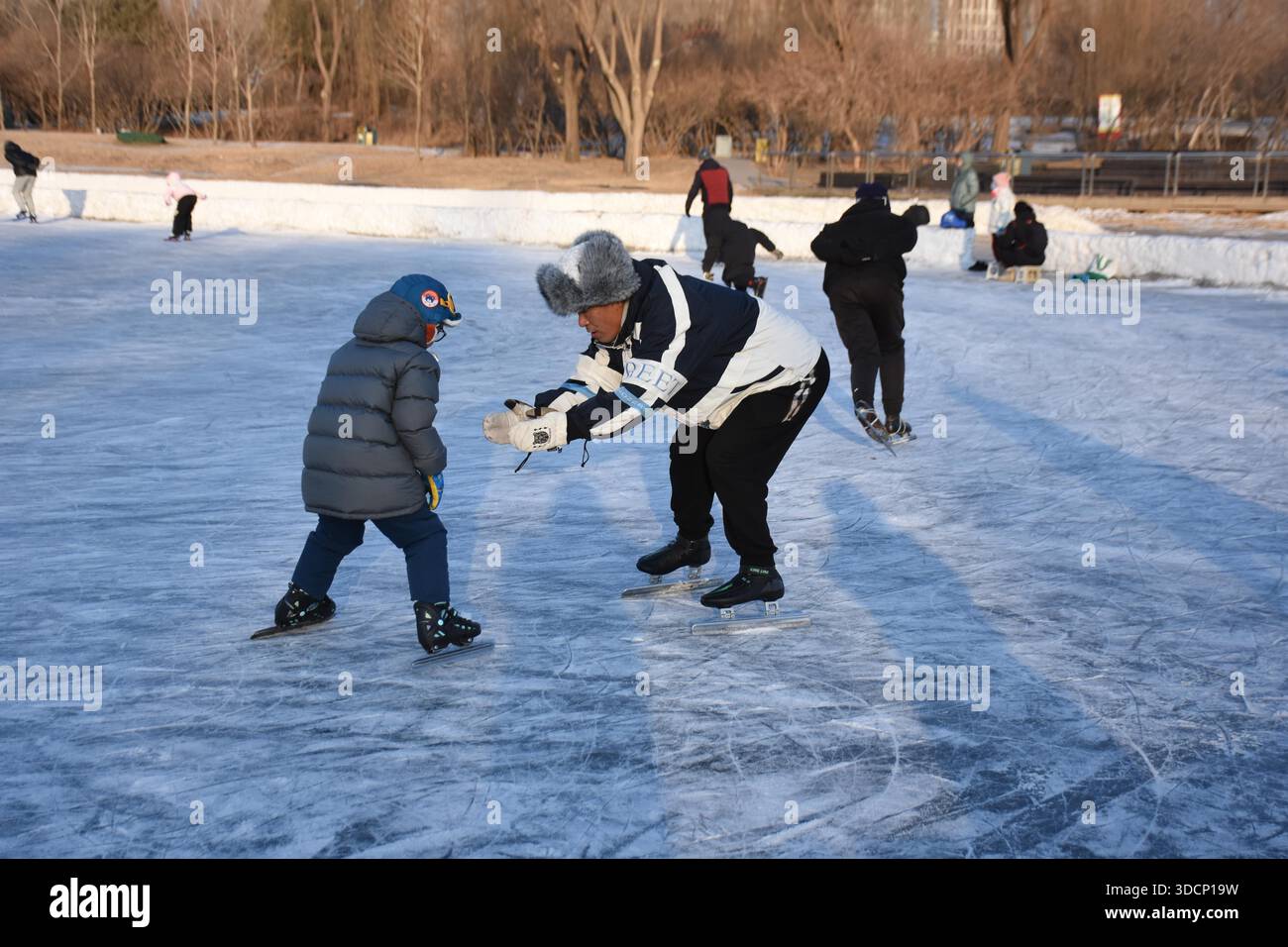 People enjoy skating at an ice rink in Harbin City, northeast China's ...