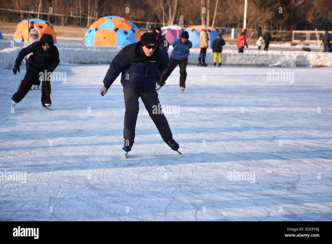 People enjoy skating at an ice rink in Harbin City, northeast China's ...