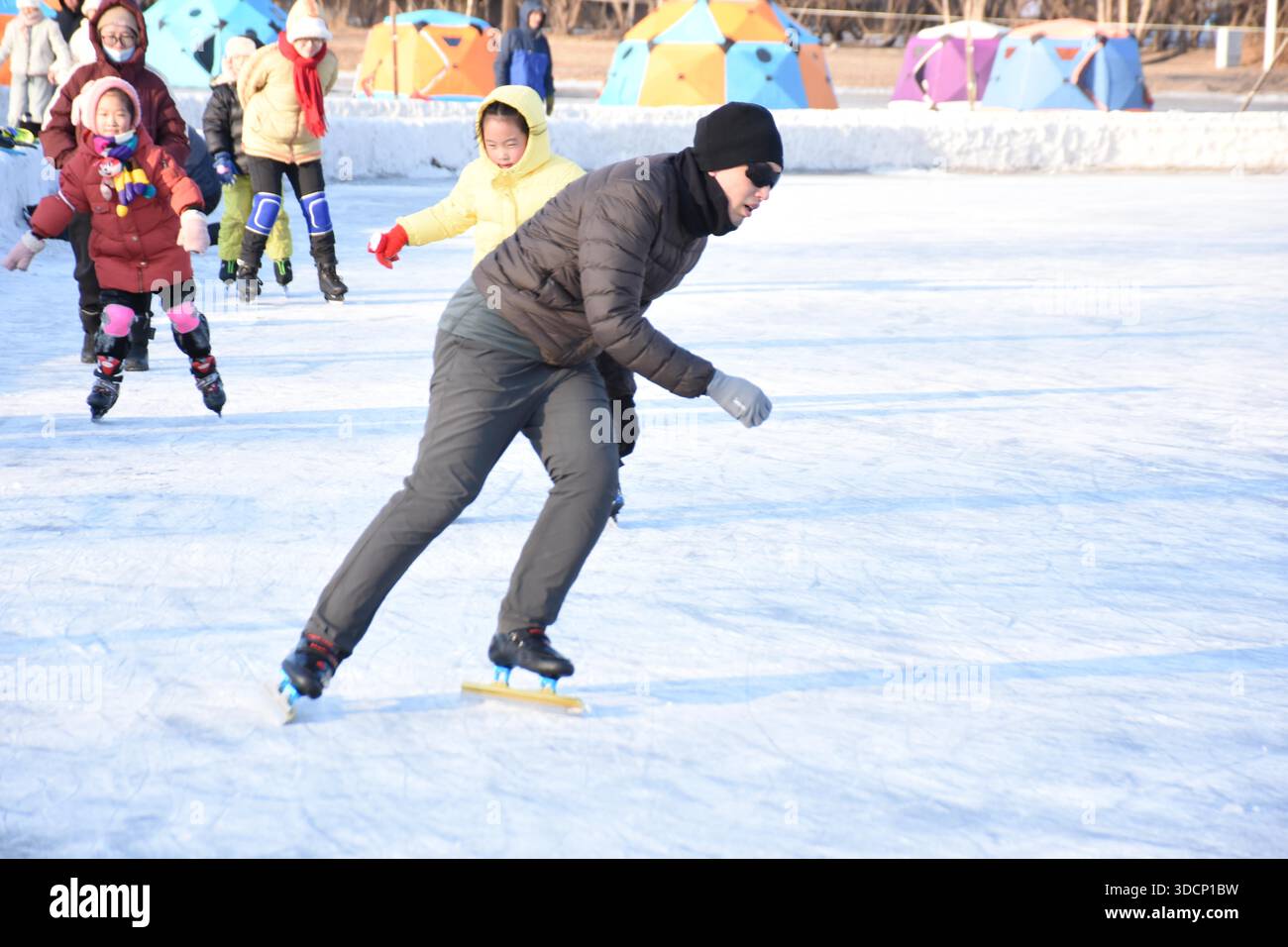 People enjoy skating at an ice rink in Harbin City, northeast China's ...