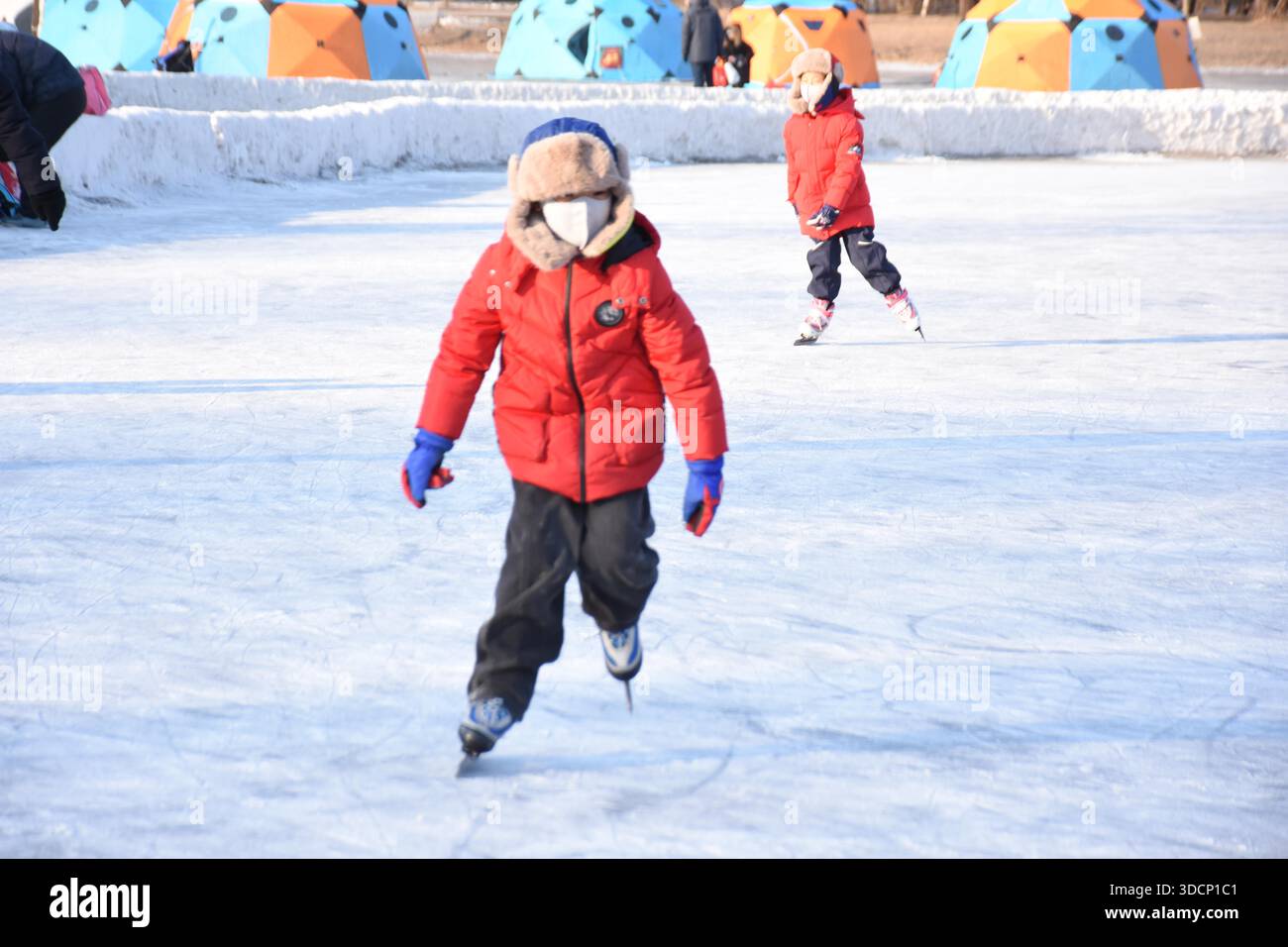 People enjoy skating at an ice rink in Harbin City, northeast China's ...