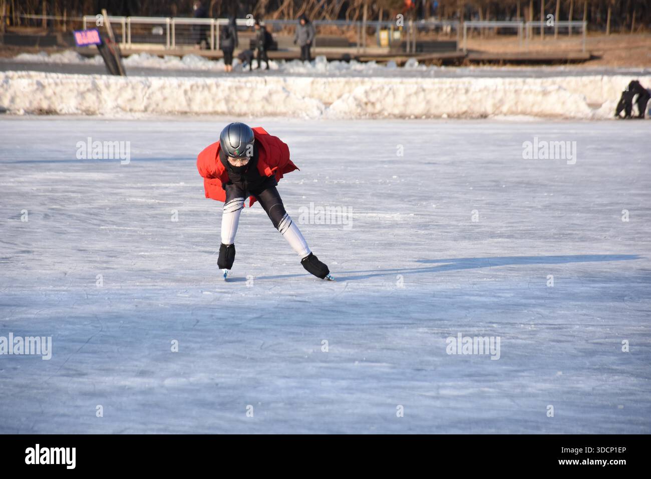 People enjoy skating at an ice rink in Harbin City, northeast China's ...