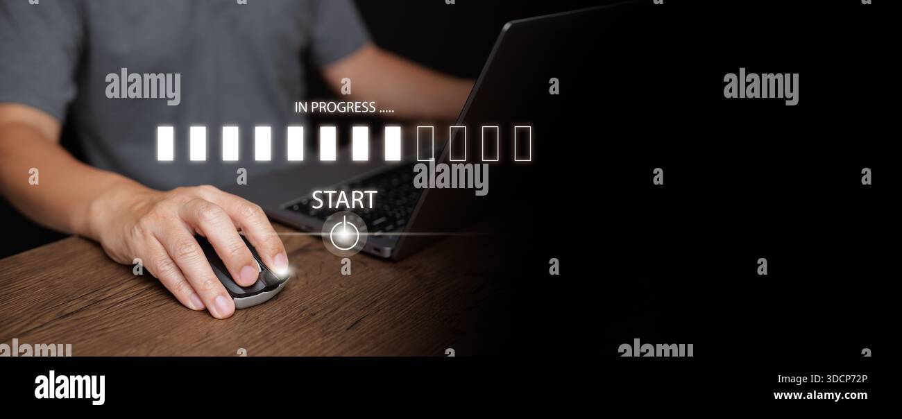 Hand using mouse and laptop with digital start button and progress bar ...
